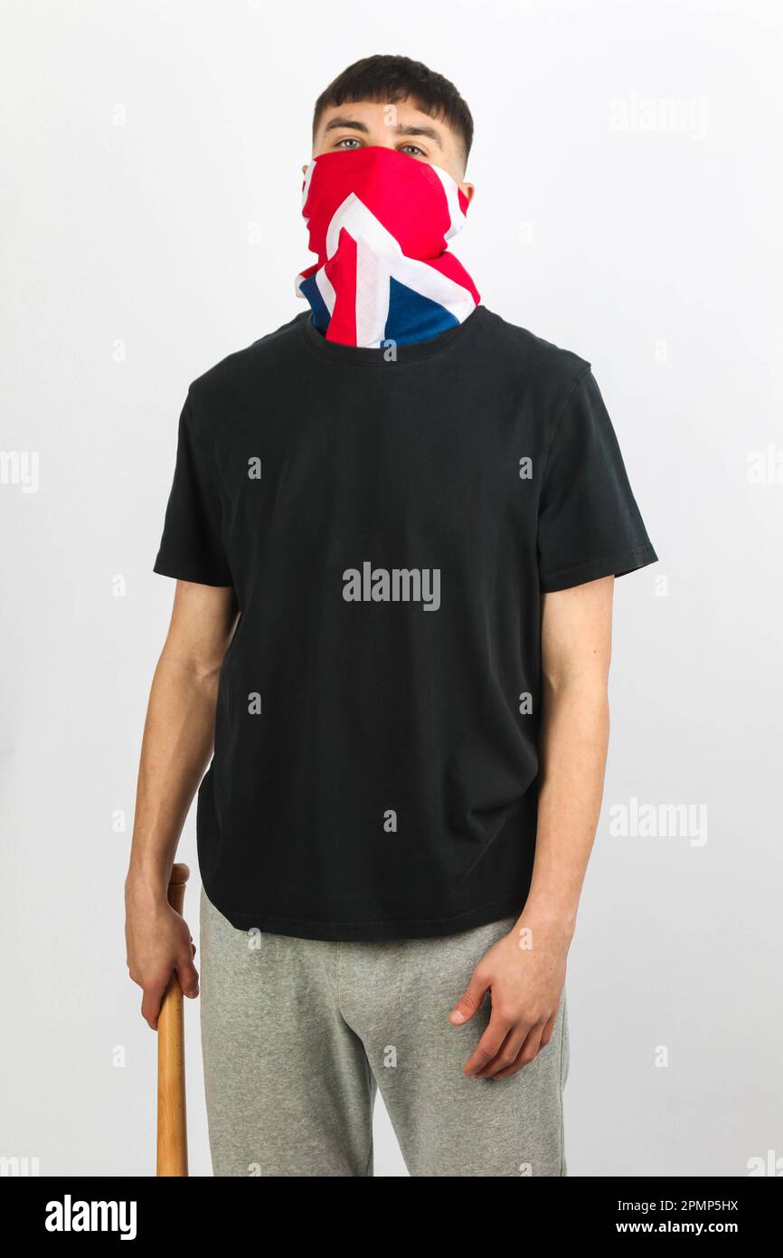 Teenage boy wearing an Union Jack mask holding a baseball bat against a ...