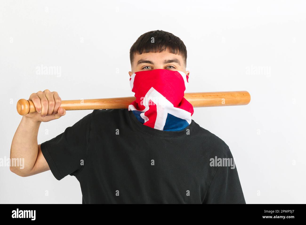 Teenage boy wearing an Union Jack mask holding a baseball bat against a ...
