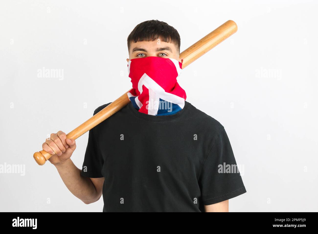 Teenage boy wearing an Union Jack mask holding a baseball bat against a ...