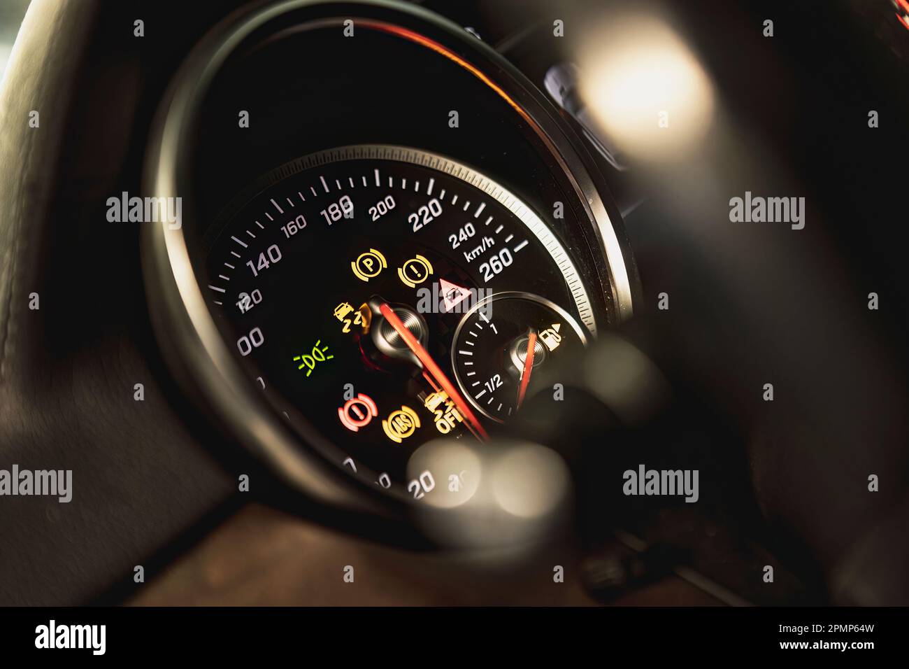 Close-up of a car dashboard with illuminated warning lights indicating ...