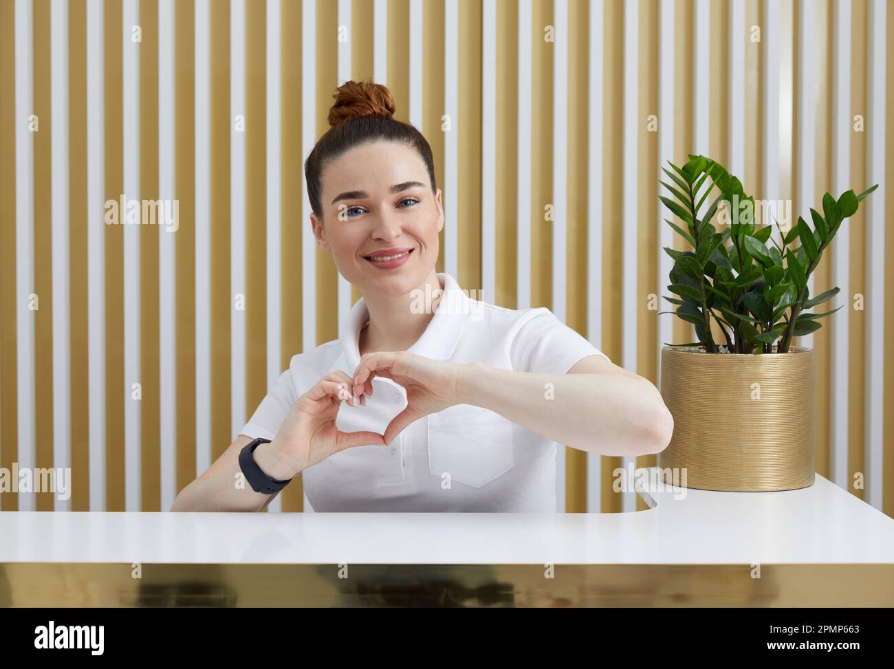 Female receptionist at reception desk in a modern office lobby Stock ...