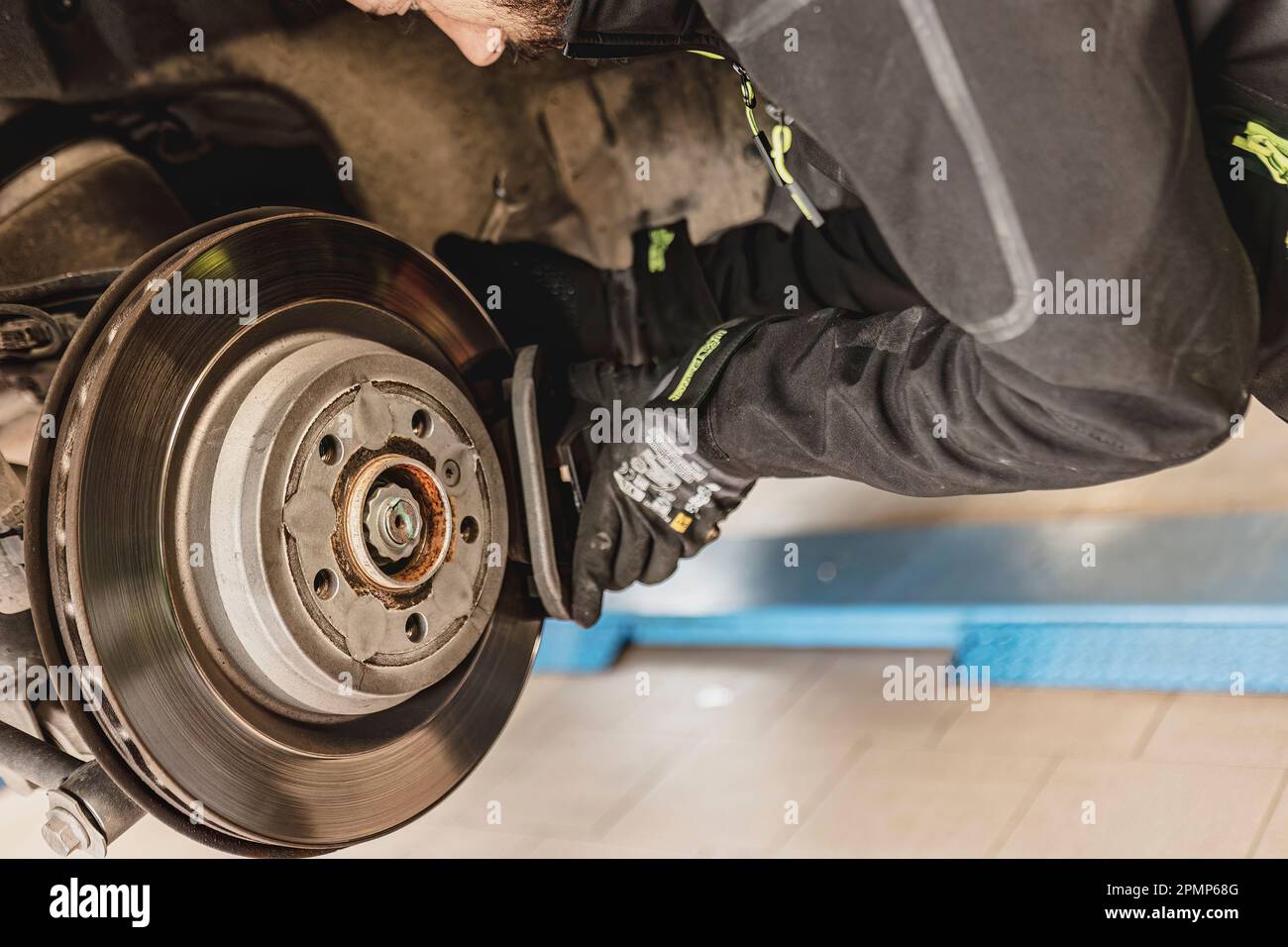 Skilled mechanic expertly replaces brake pads on a car with precision ...