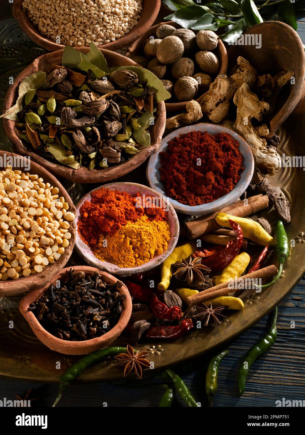 Assortment of herbs and spices in a colourful display on a tray; Studio ...