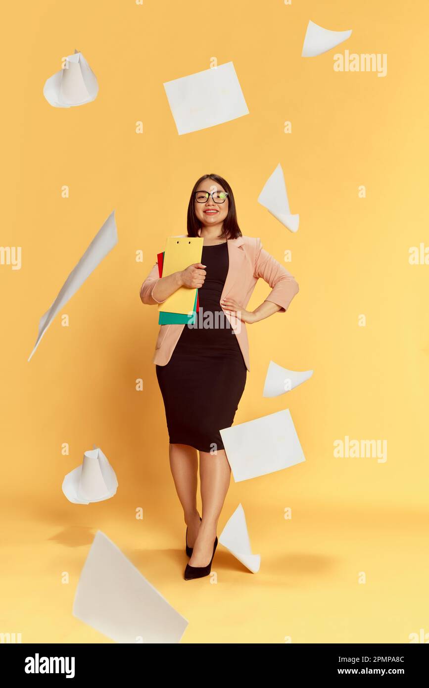 Finished tasks. Portrait of happy, young, smiling, asian girl in formal ...