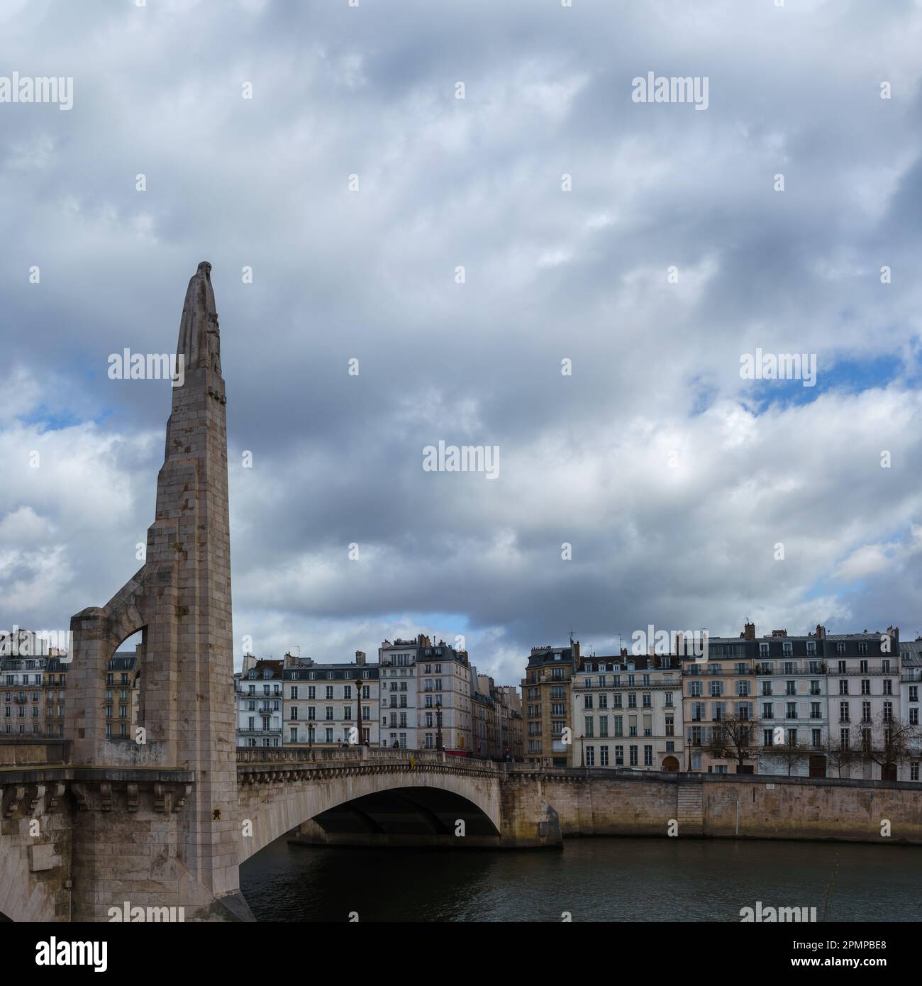 Pont de la Tournelle bridge with the statue of Saint Genevieve in Paris ...