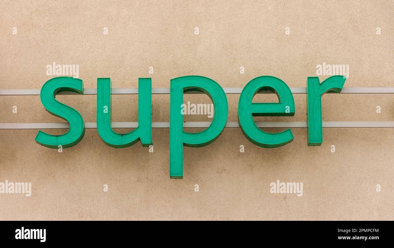 Green 3d Sign Word Super at Building Facade Wall Stock Photo - Alamy