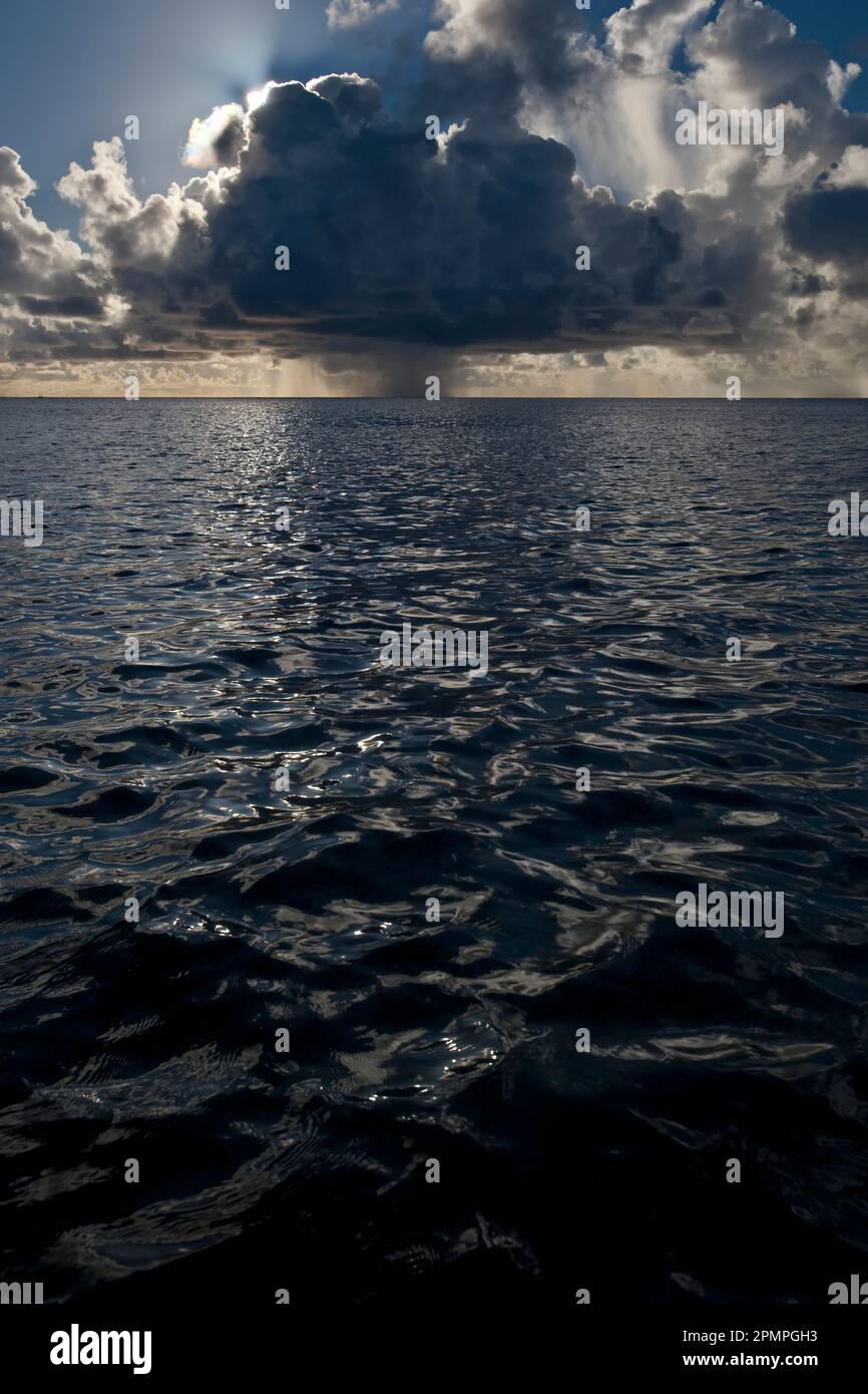 Dark storm cloud drops rain over the ocean; Seychelles Stock Photo - Alamy