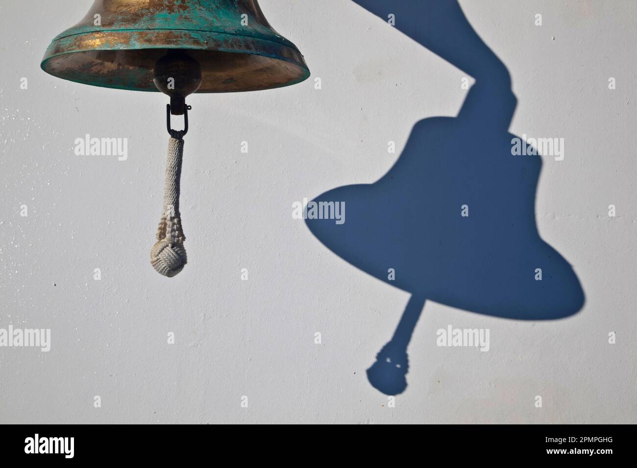 Bell casts a shadow on a white background; Mayotte, M'Bouzi Island ...