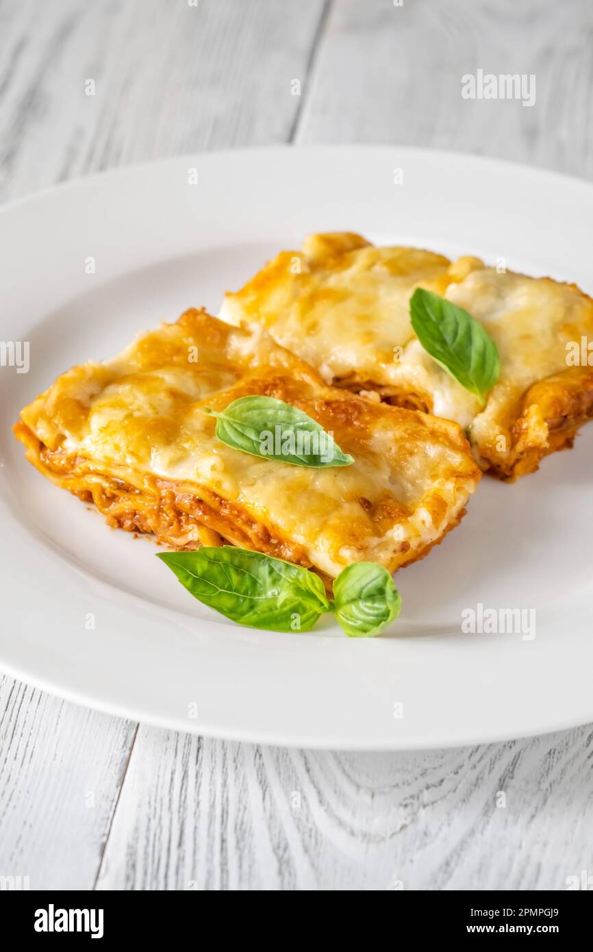 Portion of traditional lasagna with basil leaves Stock Photo - Alamy