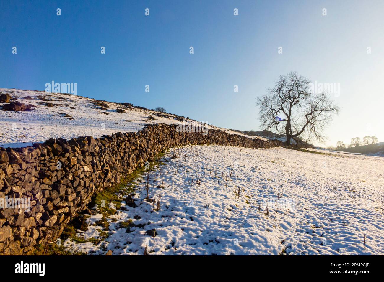 Drystone wall with show and blue sky near Roystone Grange and Parwich ...