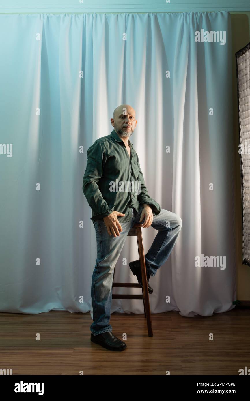 Young man sitting on box, studio hi-res stock photography and images ...
