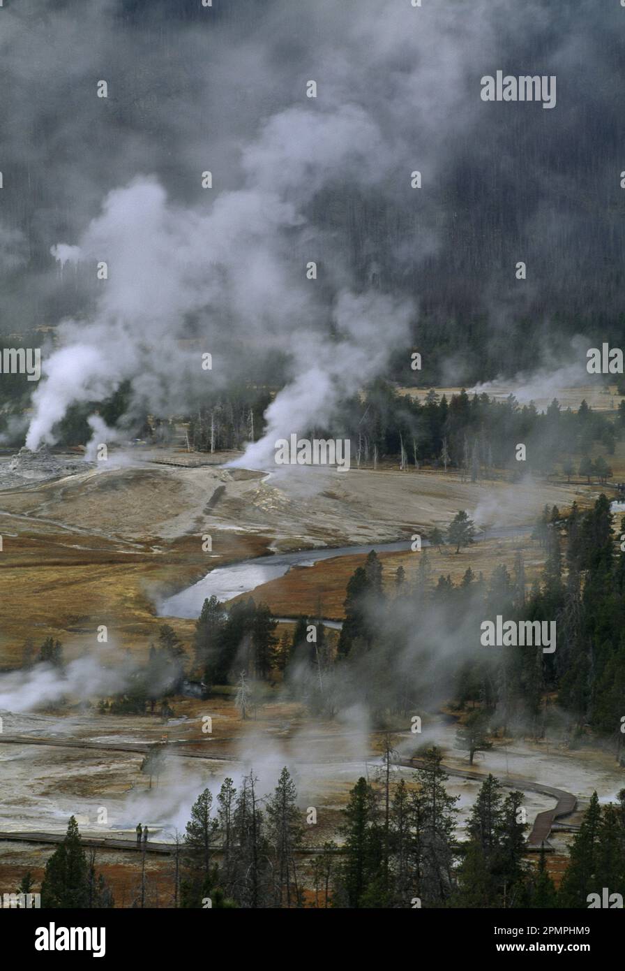 Steam rises from geothermal hot springs and geysers in Yellowstone ...