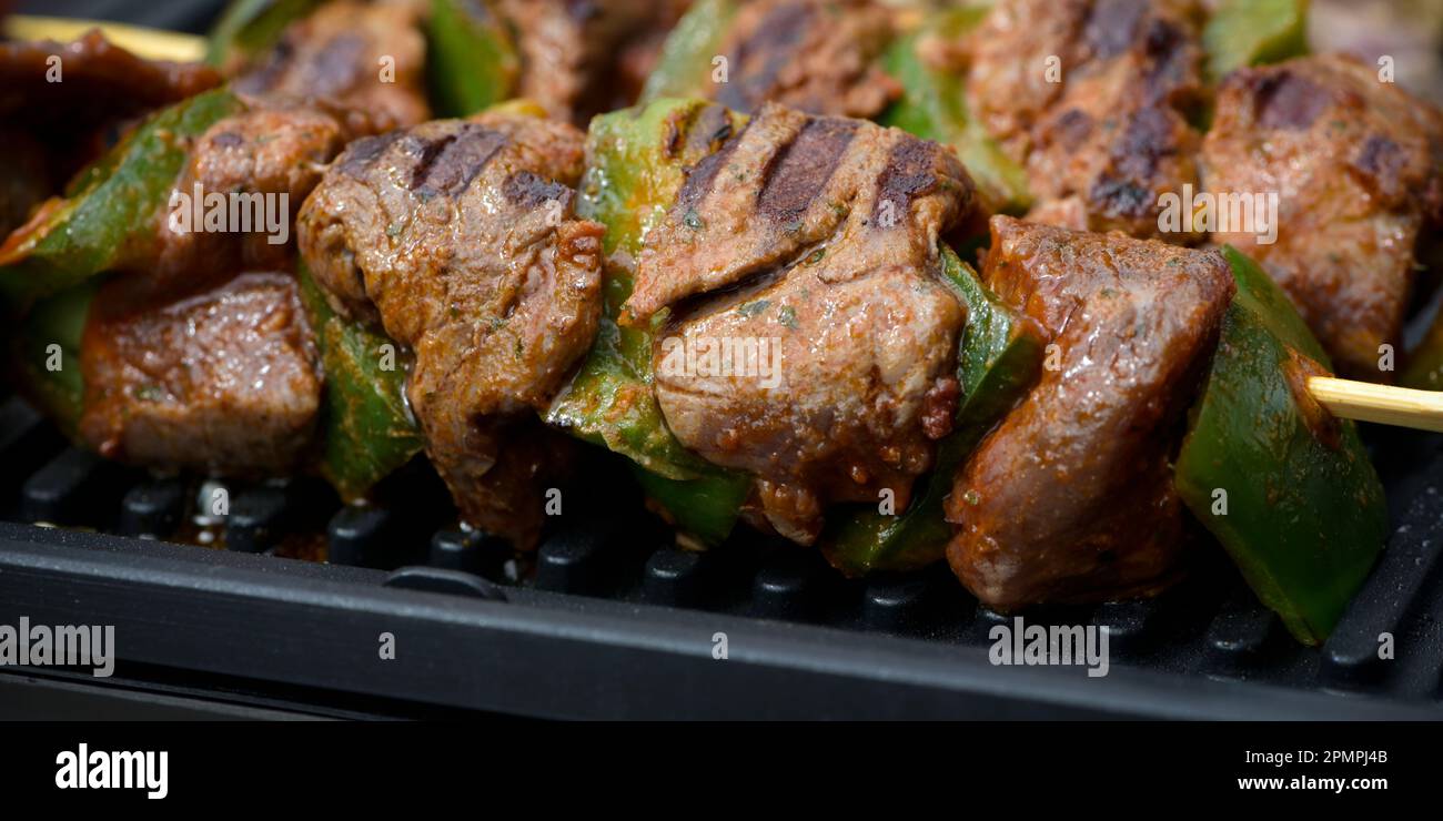 view of beef being cooked on a griddle in outdoor Stock Photo - Alamy