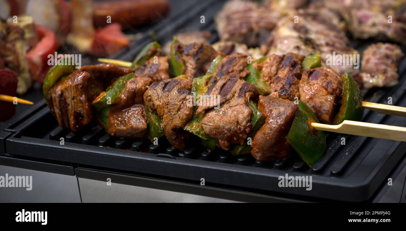 view of beef being cooked on a griddle in outdoor Stock Photo - Alamy