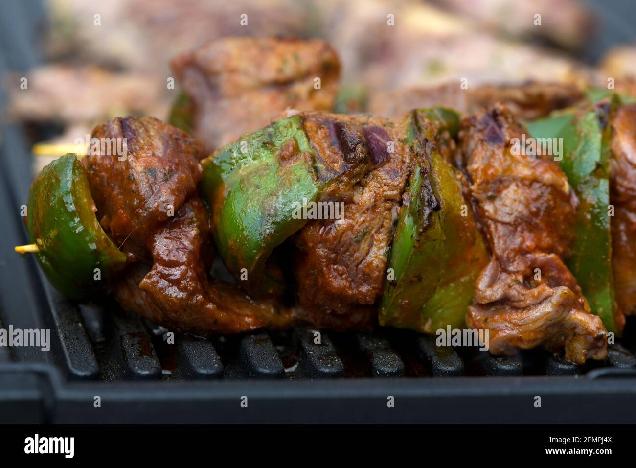 view of beef being cooked on a griddle in outdoor Stock Photo - Alamy