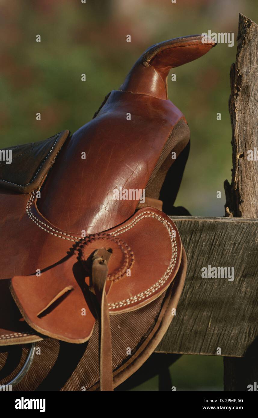 Western riding saddle sitting on a wooden fence rail; Costa Rica Stock ...
