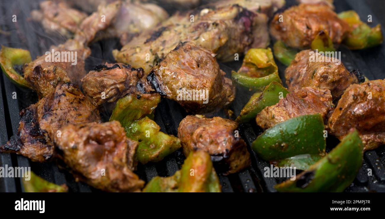 view of beef being cooked on a griddle in outdoor Stock Photo - Alamy