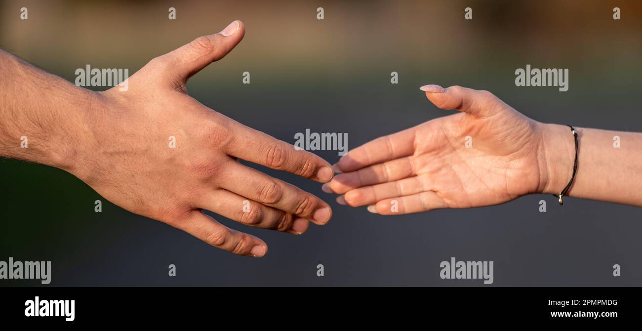 A high-resolution close-up shot of two hands held together, creating an ...