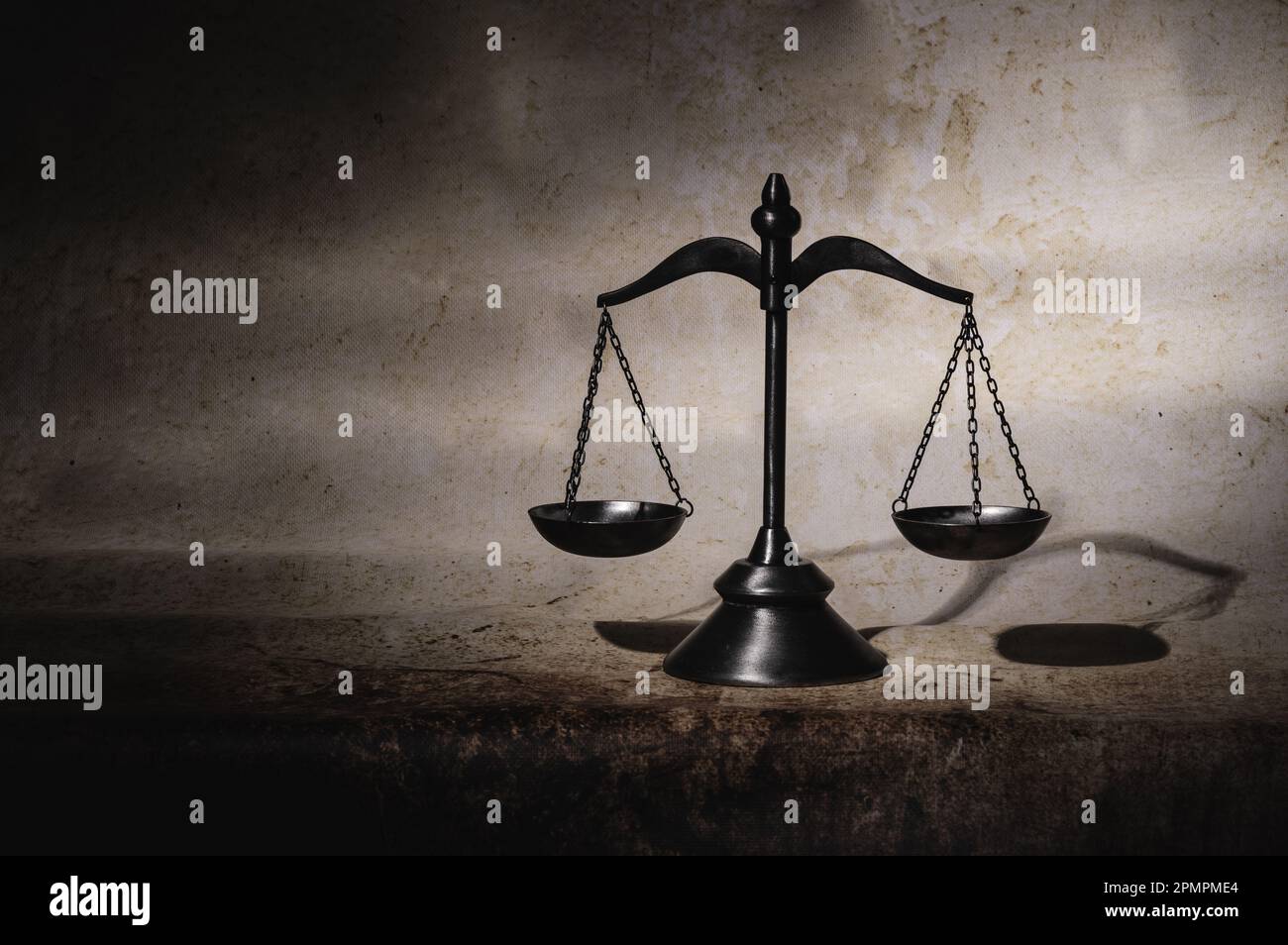 An antique-style metal balance scale with two opposing arms ...