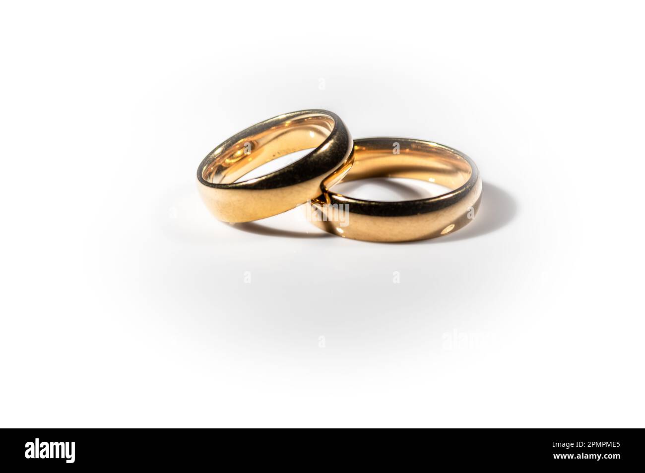 Two shining gold wedding rings isolated on white background ...