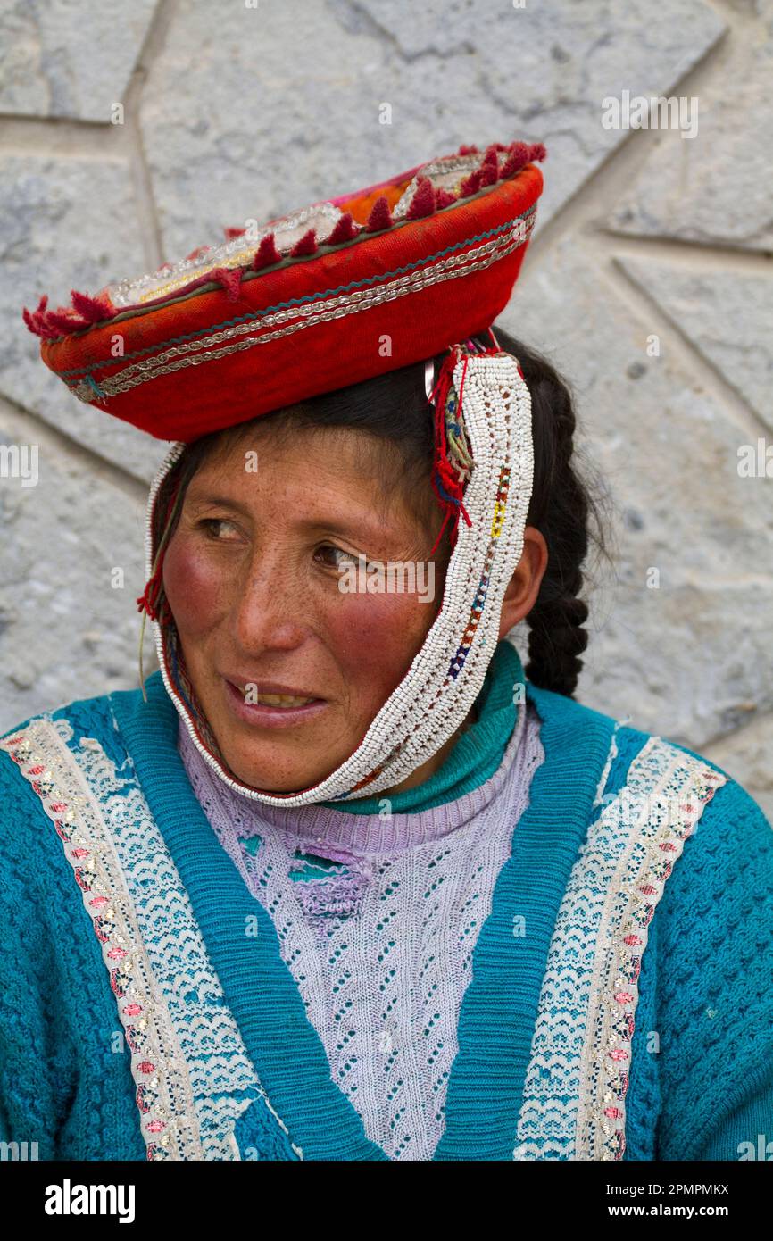 Peruvian woman sits in the square of Ollantaytambo, Peru; Ollantaytambo ...