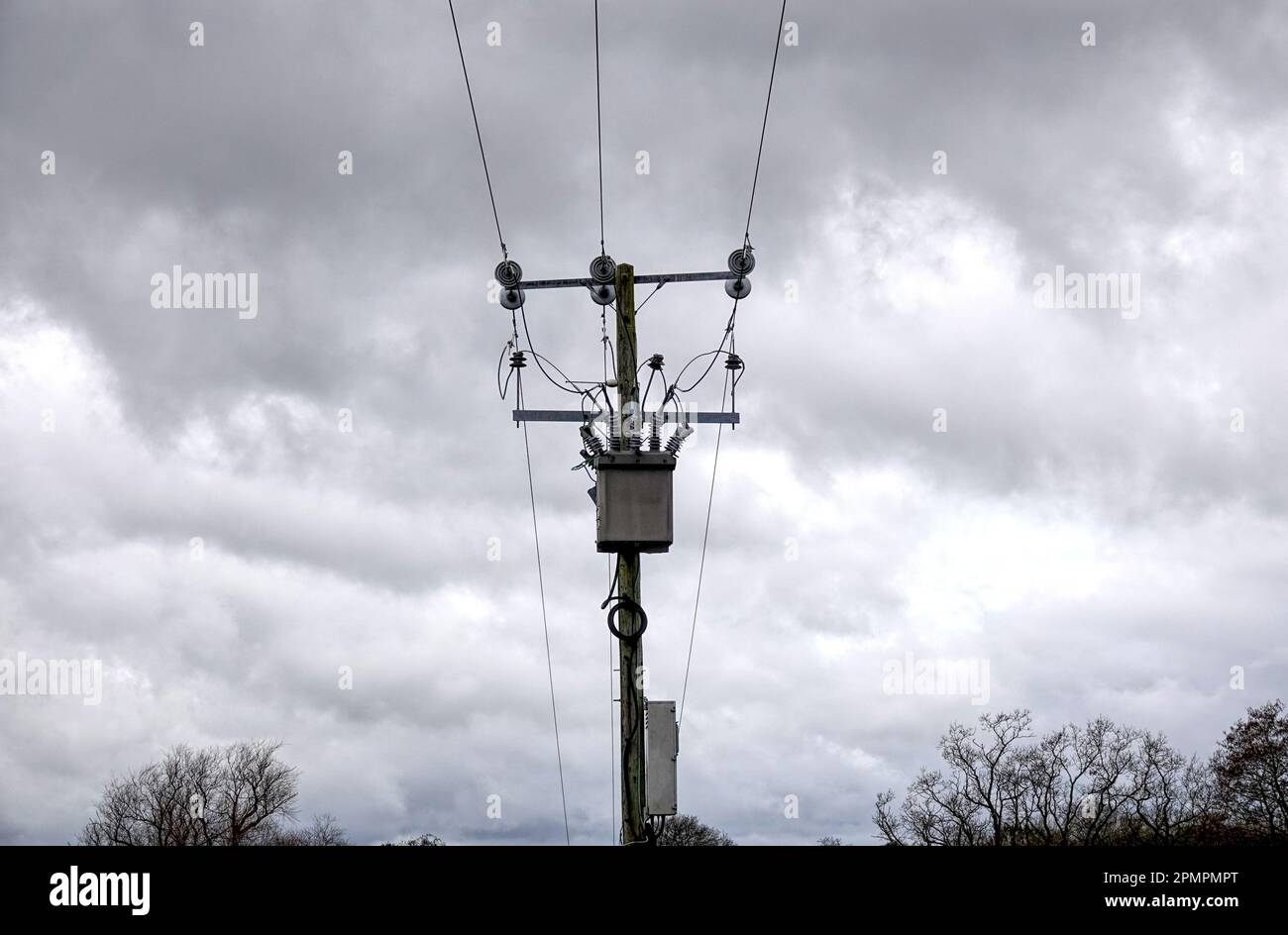 An electric power transformer mounted on wooden poles in the UK ...