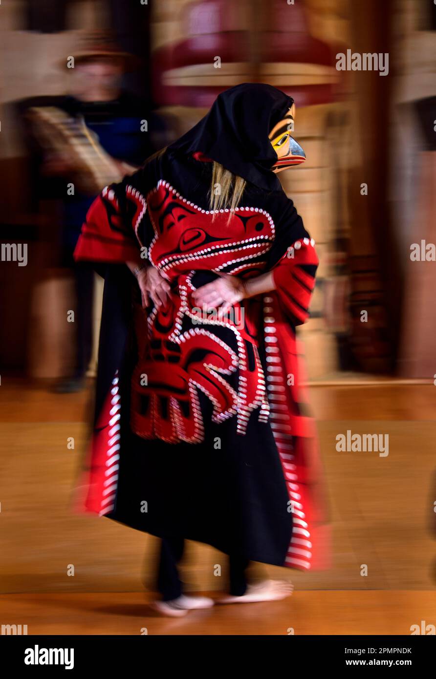 Dancer dressed as a totem spirit performing traditional Haida dance at ...