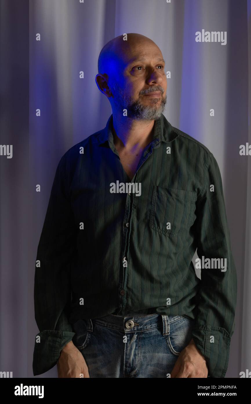 Standing man, with a beard and bald, slim, in formal clothes. Studio ...