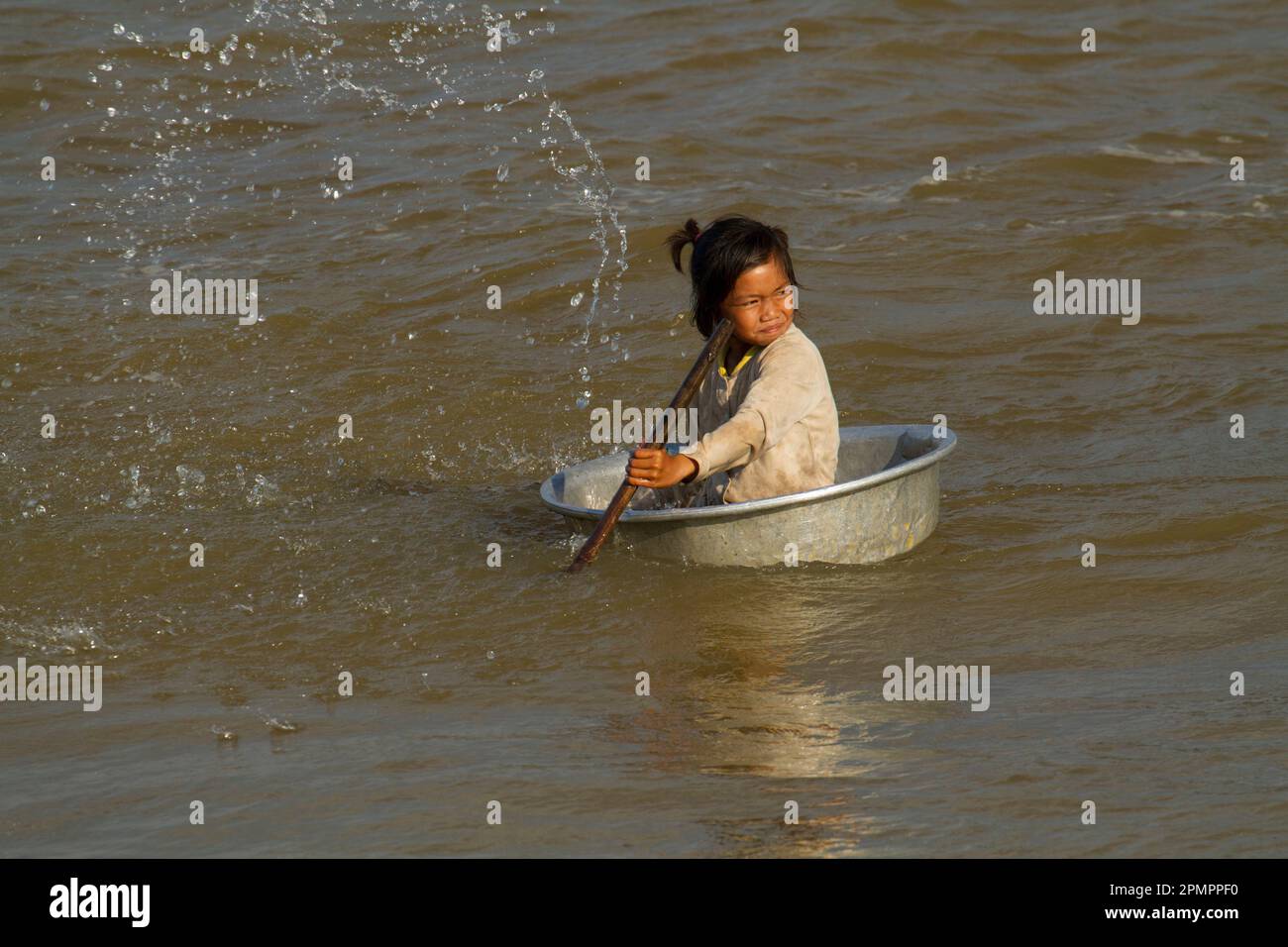 Child gets splashed in a boat on 'The Great Lake' or Tonle Sap; Tonle ...