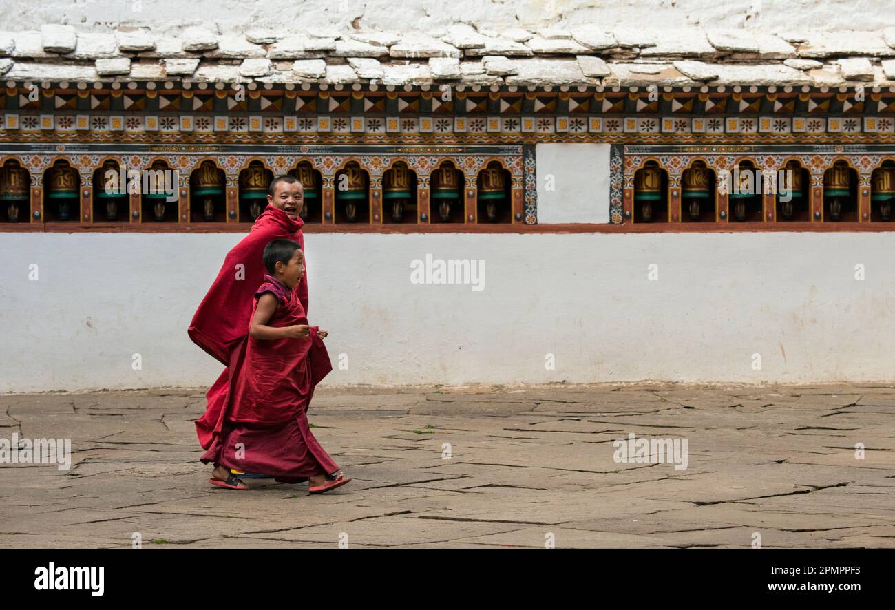 Two young monks walking through a monastery; Paro Valley, Bhutan Stock ...