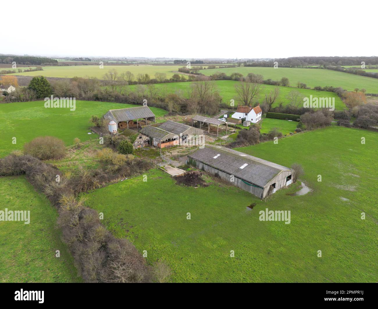 Drone view of a derelict dairy farm showing the cow sheds and grain ...