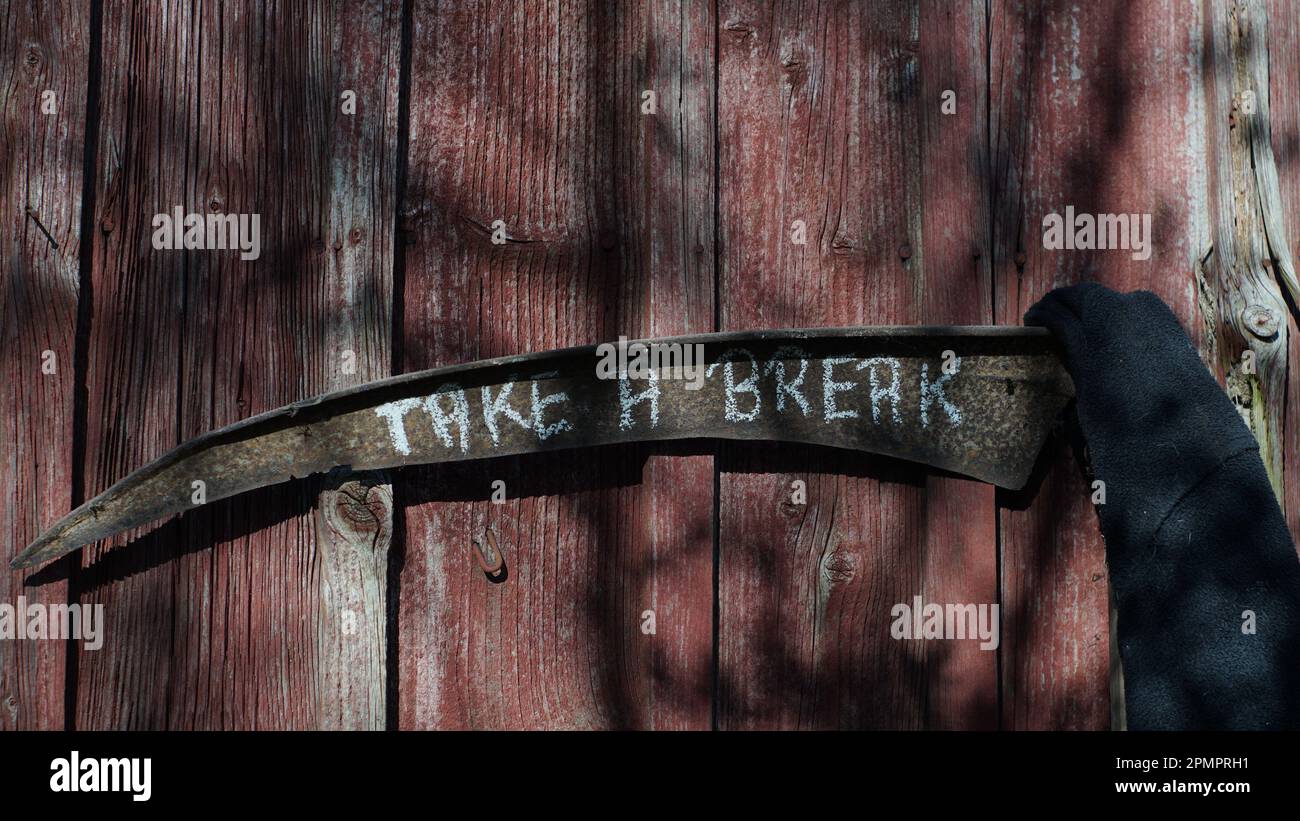 A.scythe with the words "Take a break" written on it. Symbol for death ...