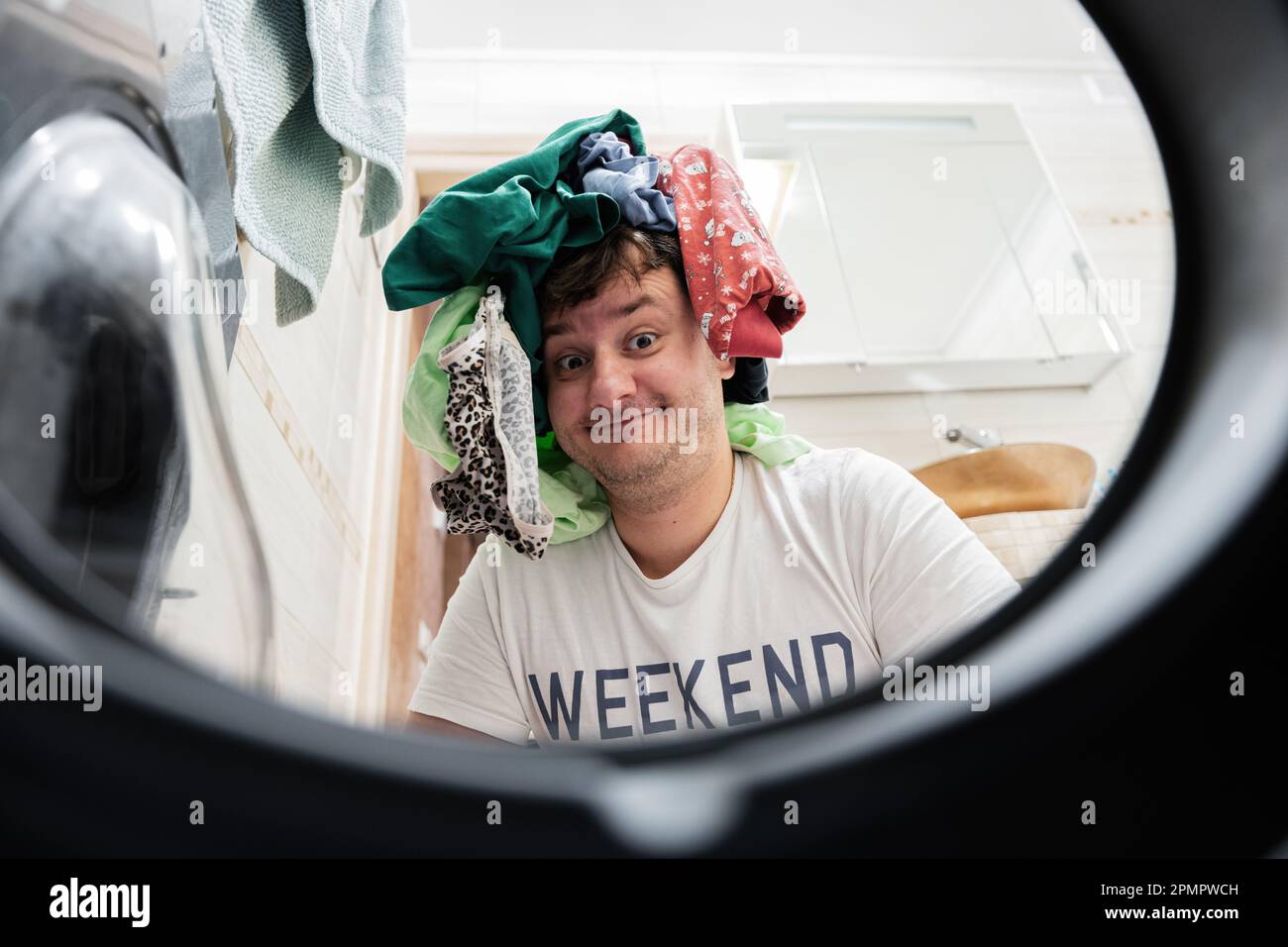 Funny man view from washing machine inside. Male does laundry daily ...
