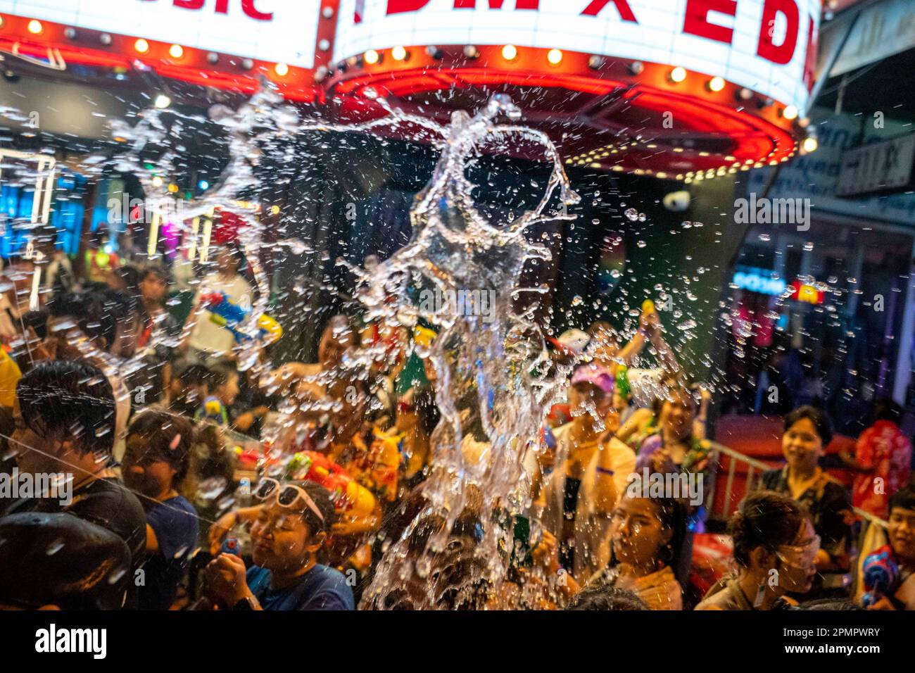 Bangkok, Bangkok, Thailand. 14th Apr, 2023. A splash of water flies through the air as nighttime ...