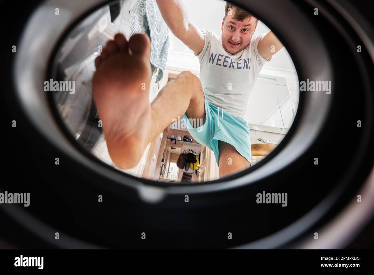 Man view from washing machine inside. Male does daily routine. Climbs ...