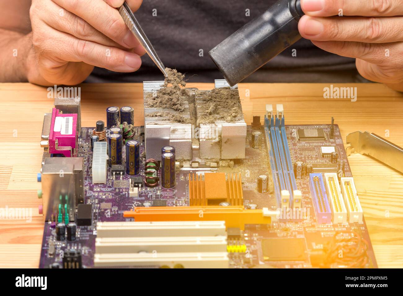 Cleaning the motherboard. Dirt on the processor. Tweezer for cleaning ...