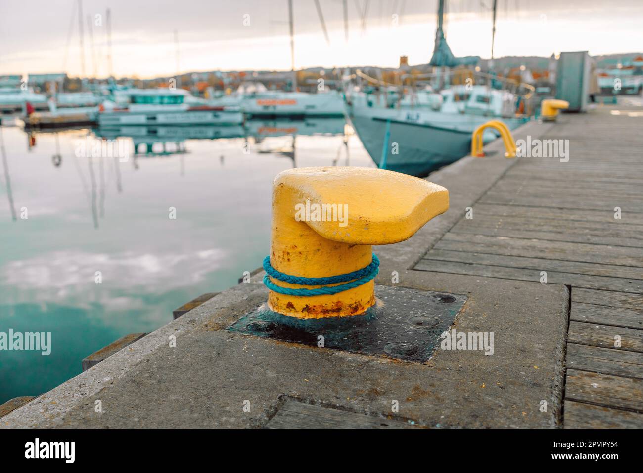 Old rusty iron yellow mooring bollard at sea. Sopot, Poland Stock Photo ...