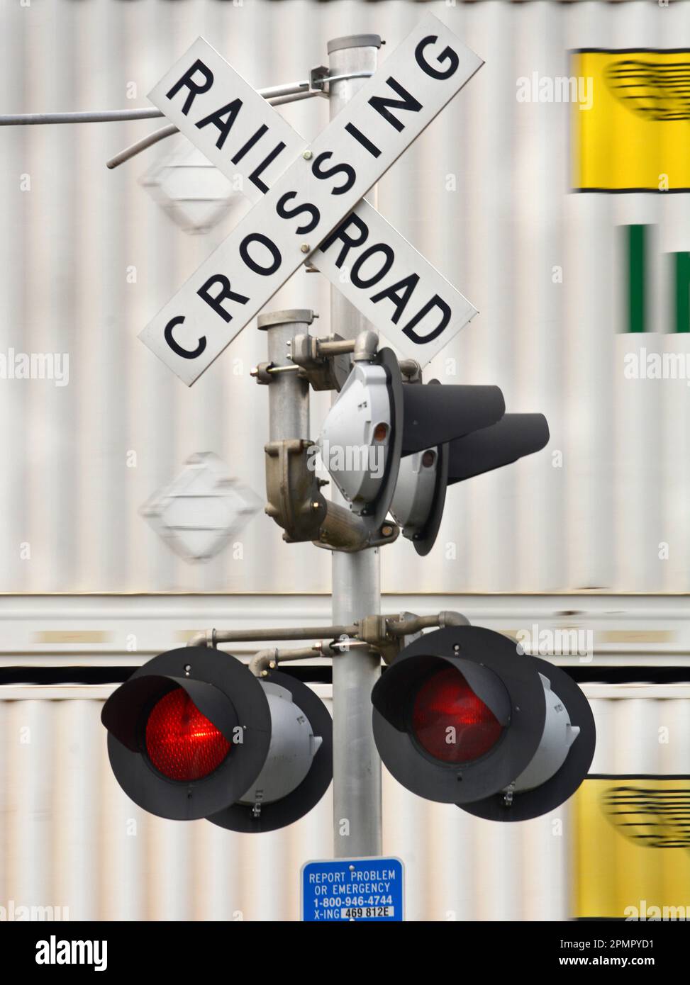 A railroad crossing signal flashes lights as a Norfolk SouthernRailways ...