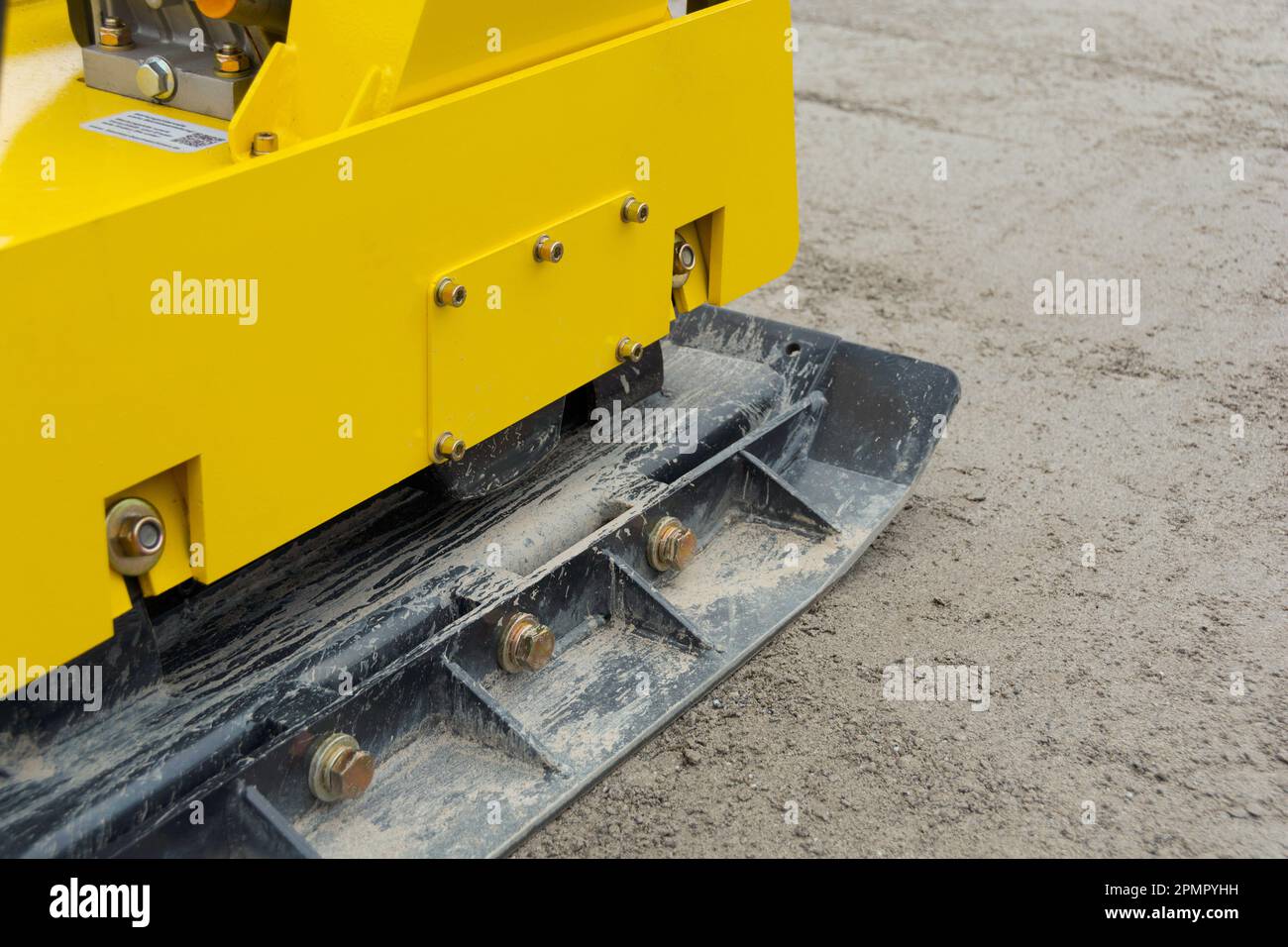 Vibratory plate compacts gravel base layer Stock Photo - Alamy