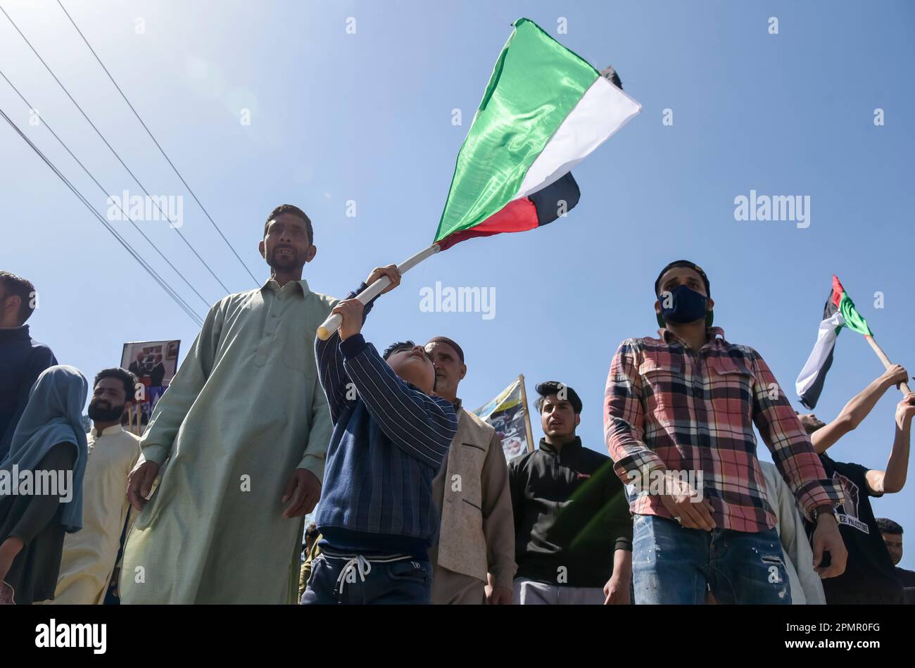 Srinagar, India. 14th Apr, 2023. A Muslim Kid waves a Palestinian Flag ...