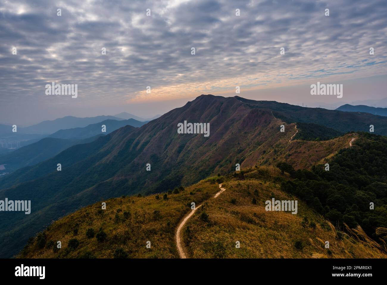 A scenic path winding along a high-rise ridge, surrounded by majestic ...