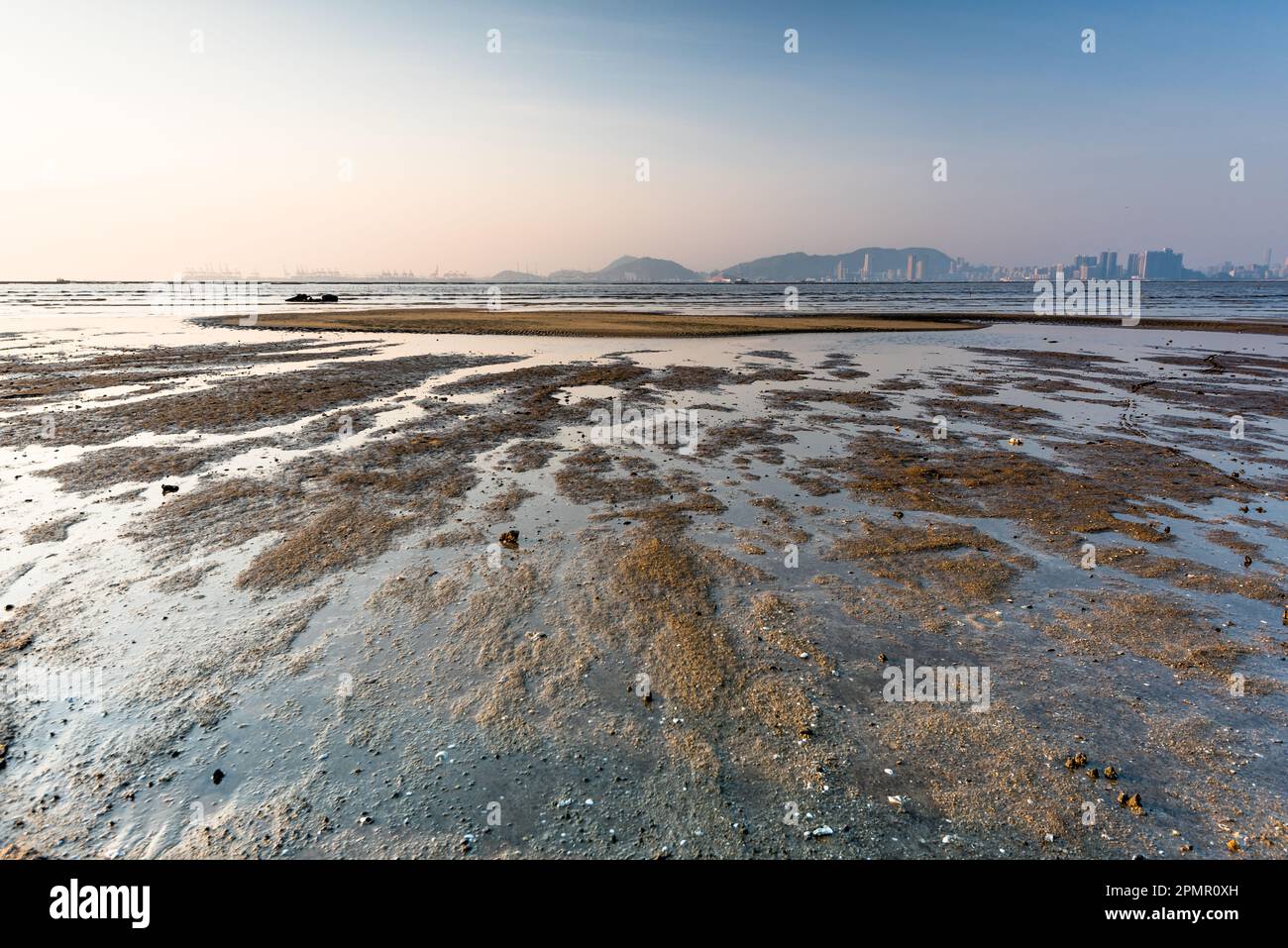 A wide expanse of ocean water visible during low tide, revealing the ...