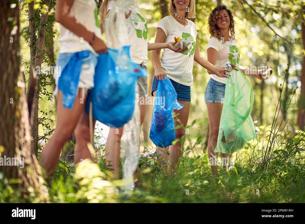Group of young handsome female ecological activists having fun while ...