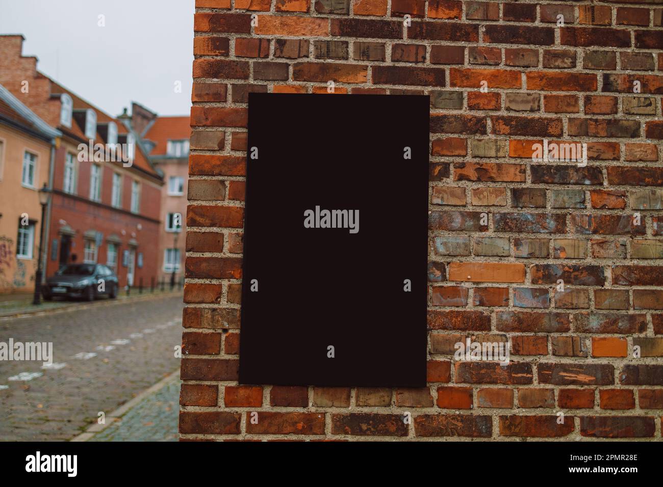 Black square signboard on an old building of a dark brick factory Stock ...