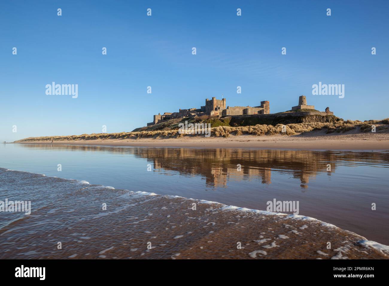 Beautiful reflection of Bamburgh Castle located on the coast at ...