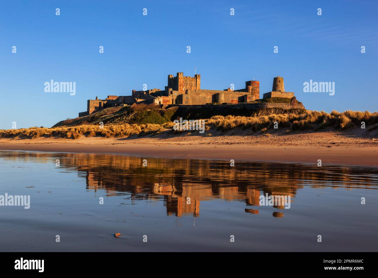 Beautiful reflection of Bamburgh Castle located on the coast at ...
