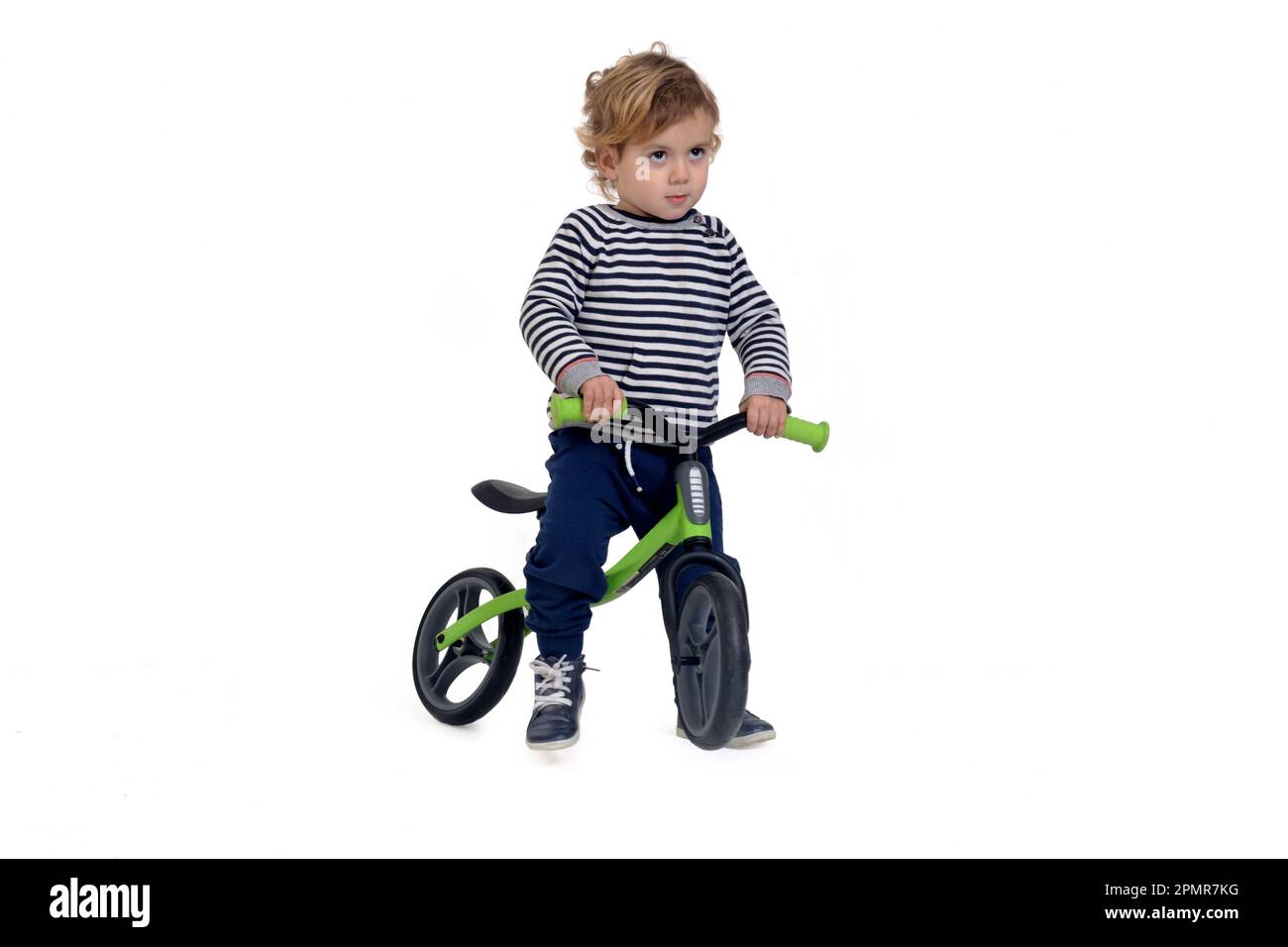 baby who rides a bike standing on white background Stock Photo - Alamy
