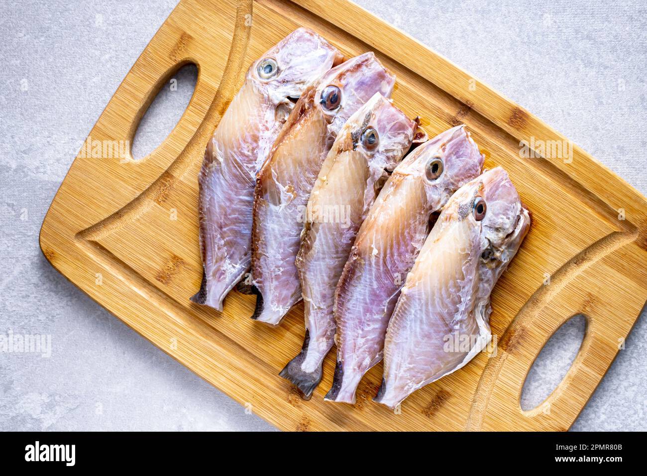 Fish "peroa" clean on the wooden board and coriander, ready to fry. Traditional Brazilian beach ...