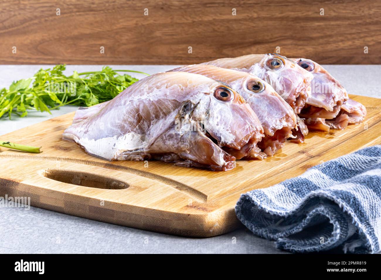 Fish "peroa" cleaned on the wooden board ready to fry. Traditional ...