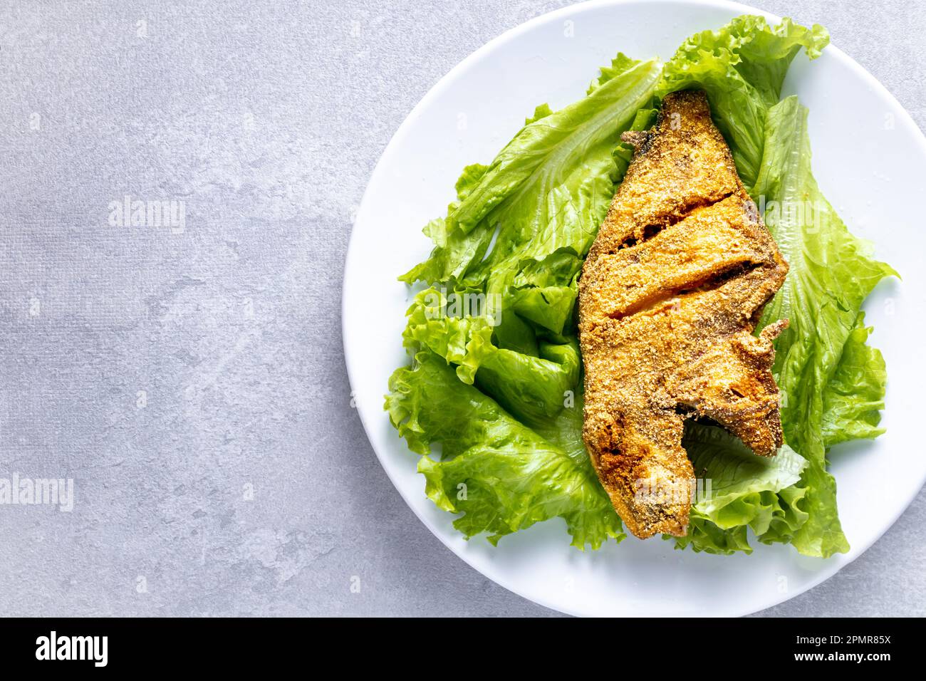Fried "peroa" fish with lettuce salad. Traditional Brazilian beach food ...